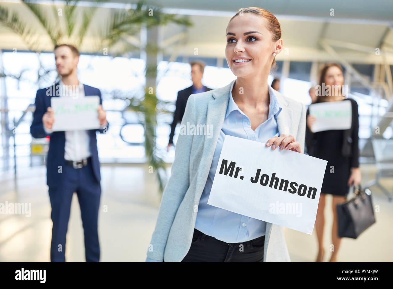 Reception of travelers at the airport with sign by group Stock Photo ...