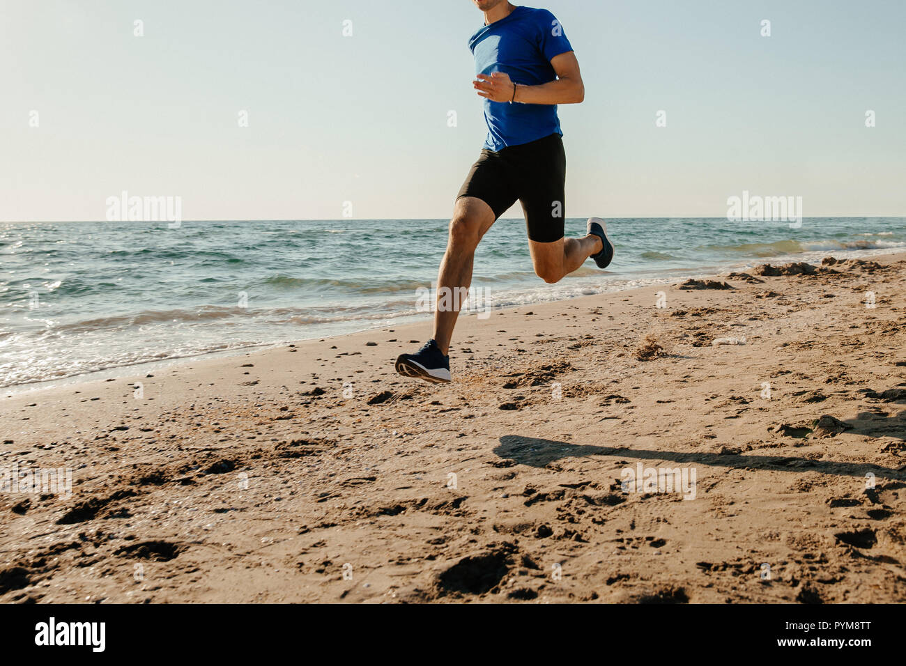 athlete runner running on sandy beach of sea coast Stock Photo - Alamy