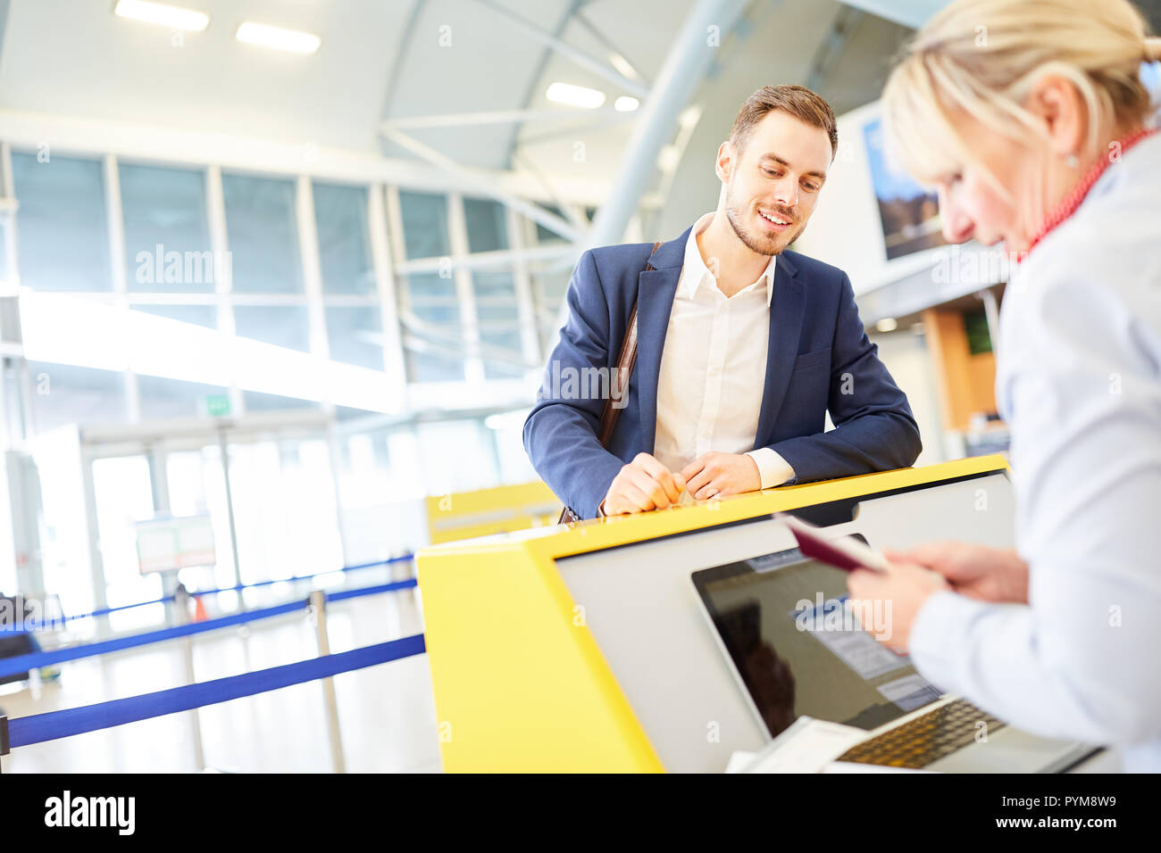 Service Agent inspects passport or boarding pass from business man at ...