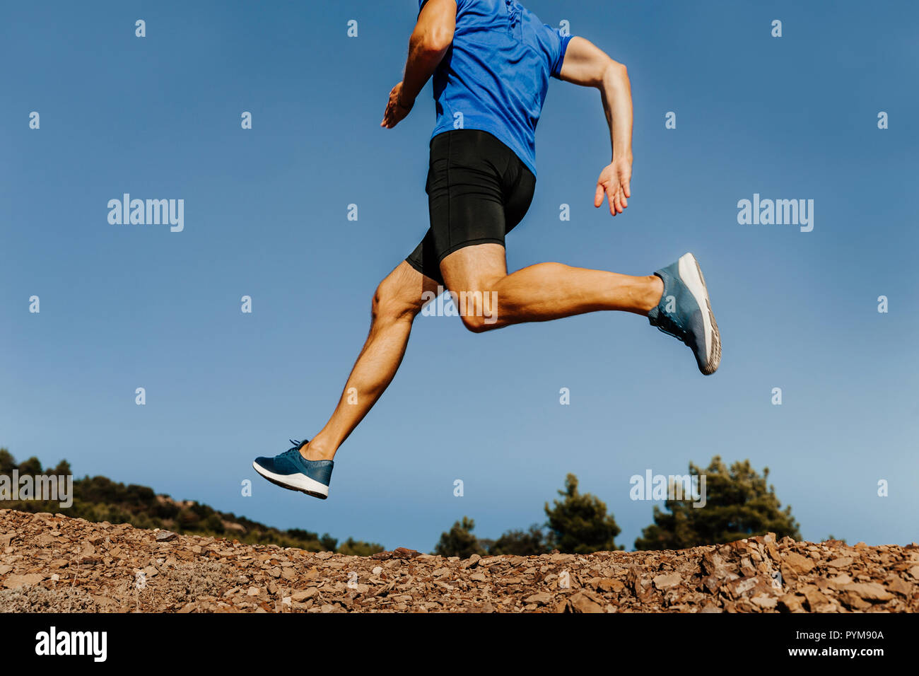 side view legs male runner running on mountain trail Stock Photo - Alamy