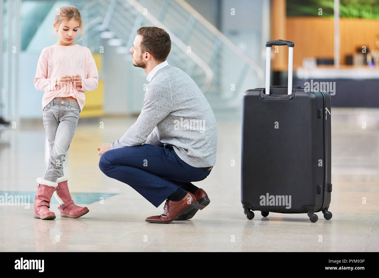 Father says goodbye to his daughter at the airport terminal before ...