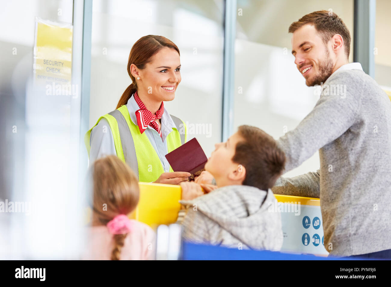 Woman as a service agent checks passport and plane ticket at the check ...