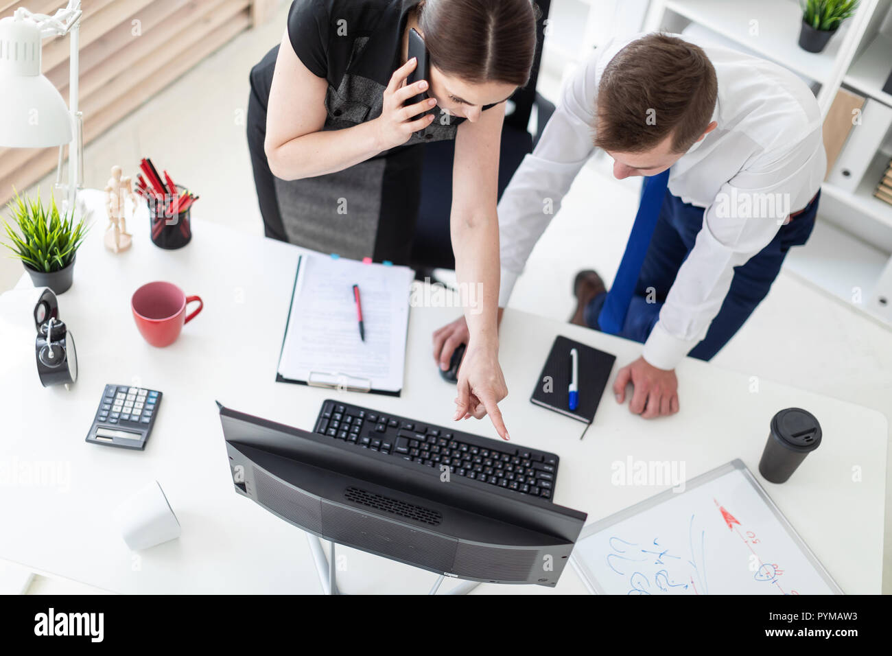 Young people in the office looking at the monitor Stock Photo - Alamy