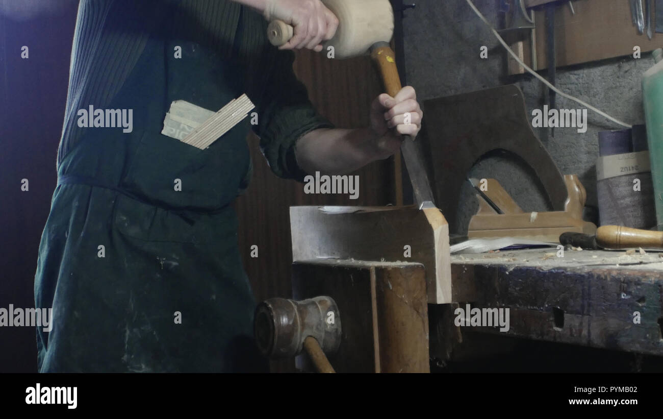 carpenter uses a carpenter's chisel Stock Photo - Alamy