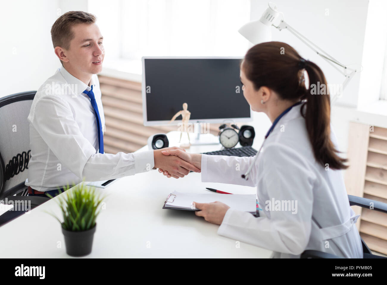 The doctor and the patient shake hands Stock Photo - Alamy