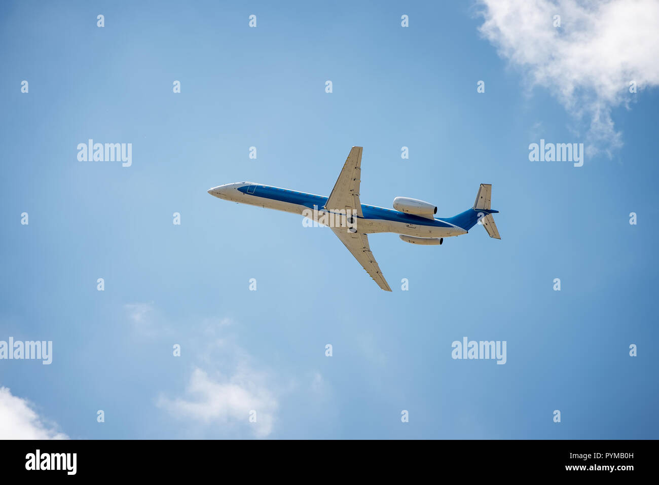 aircraft flies in the blue sky view from below Stock Photo - Alamy