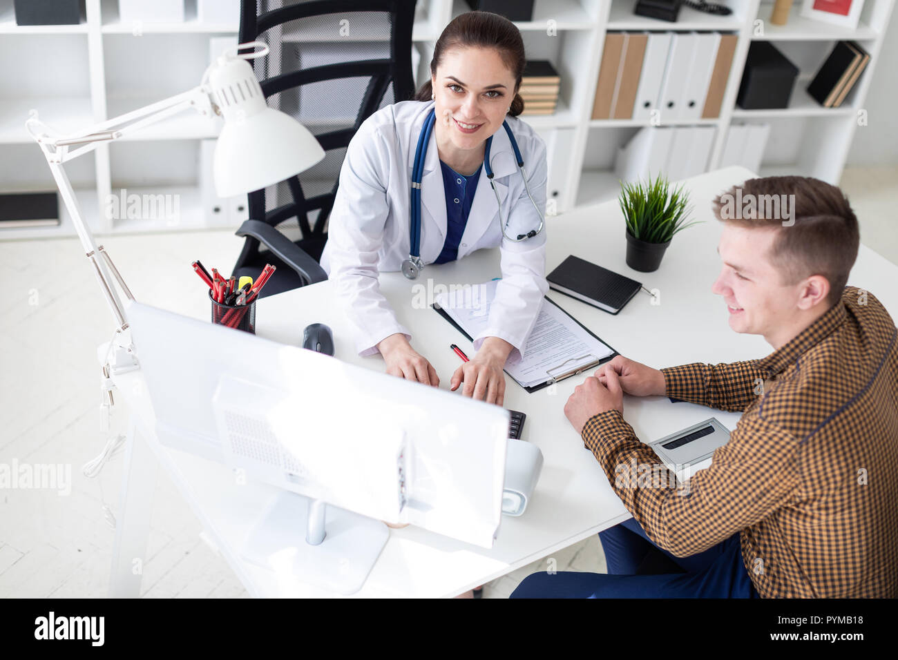 The doctor explains the problem to the patient on the computer Stock ...