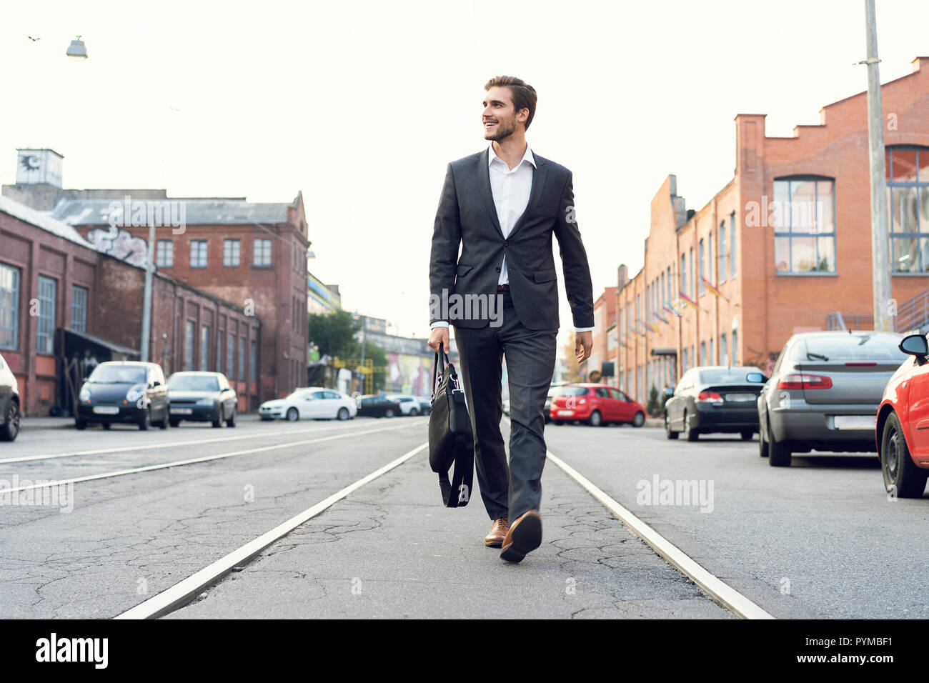 Young successful business man walking in the city in the sunset Stock ...