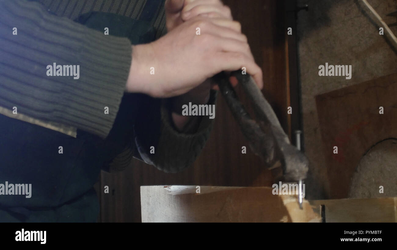 close up, carpenter draws a nail with an antique pincer Stock Photo - Alamy