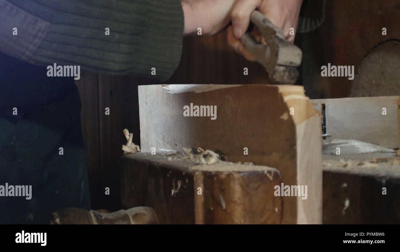 close up, carpenter draws a nail with an antique pincer Stock Photo - Alamy