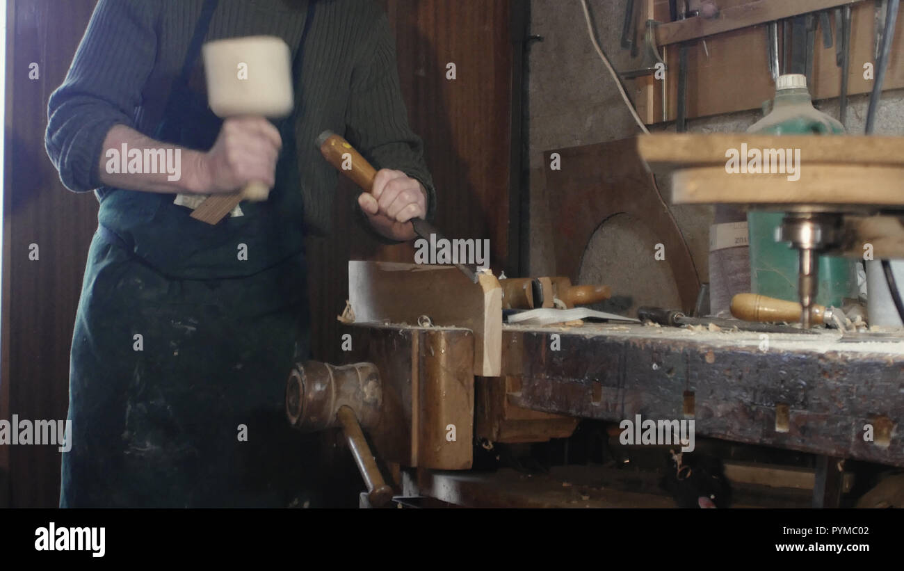 carpenter uses a carpenter's chisel Stock Photo - Alamy