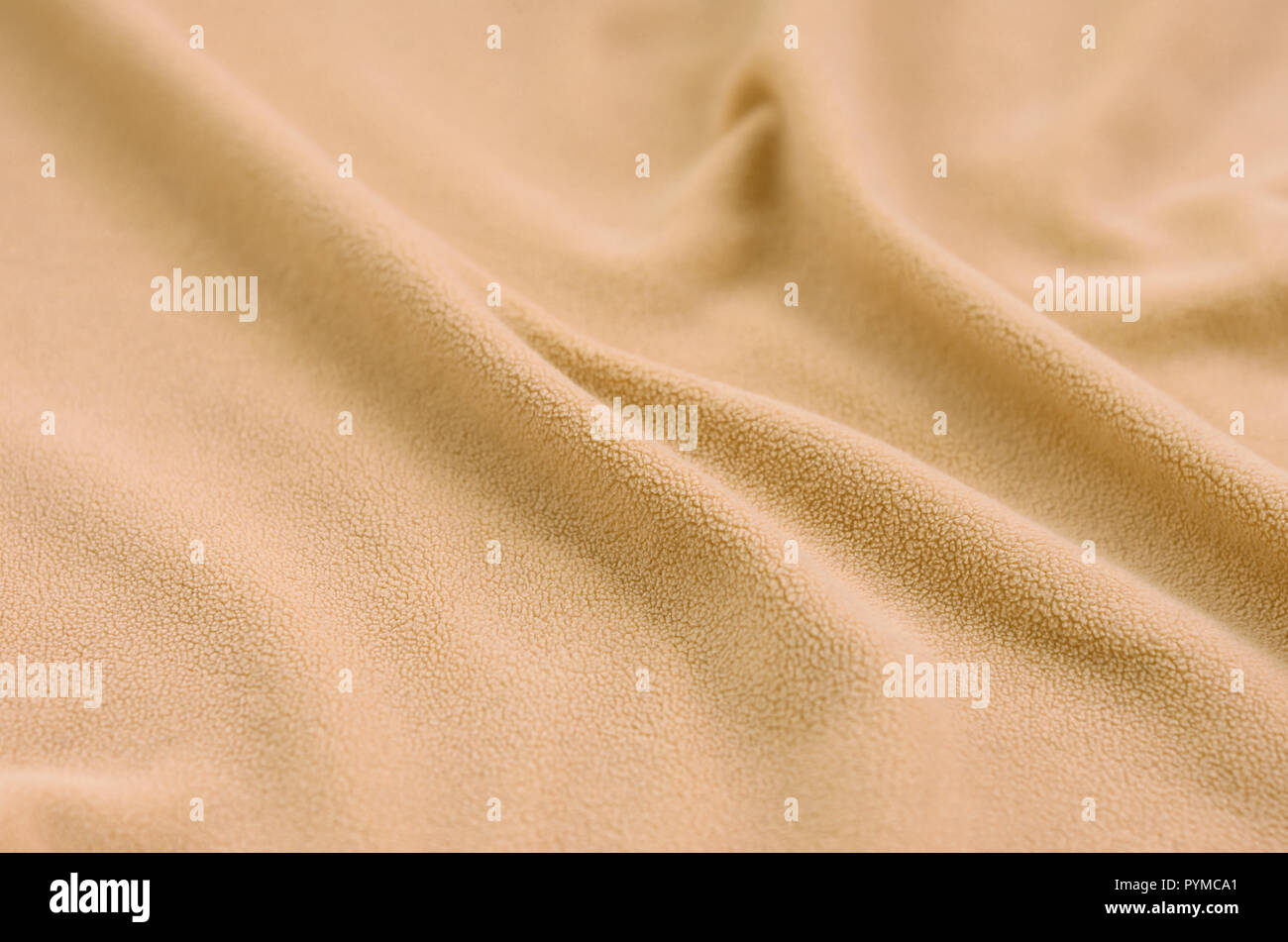 The blanket of furry orange fleece fabric. A background of light orange ...