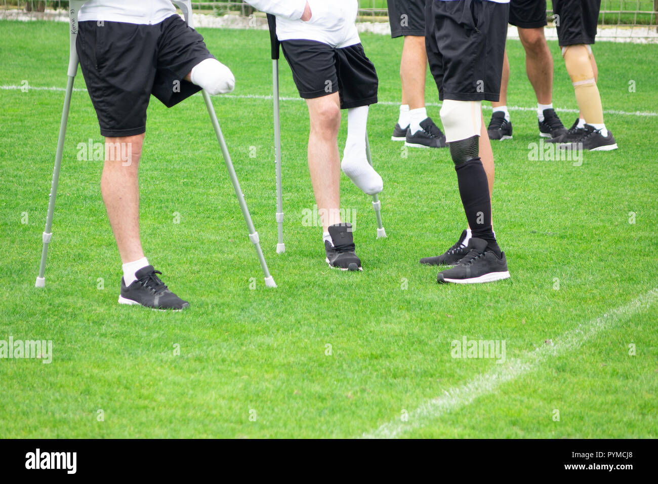 close-up of ampute soccer player and team friend Stock Photo - Alamy