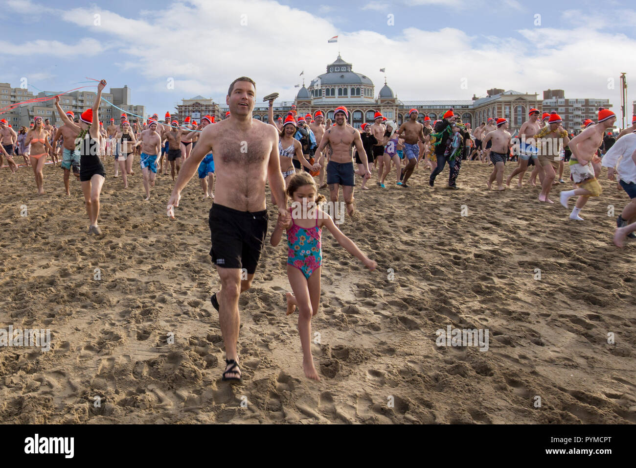 SCHEVENINGEN, 1 January 2018 - Father and his daughter running on the ...