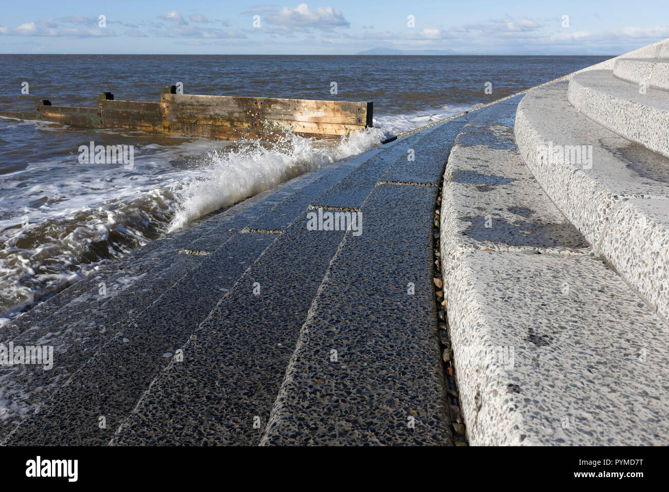 Wave breaking against concrete stepped revetment with timber groyne in ...