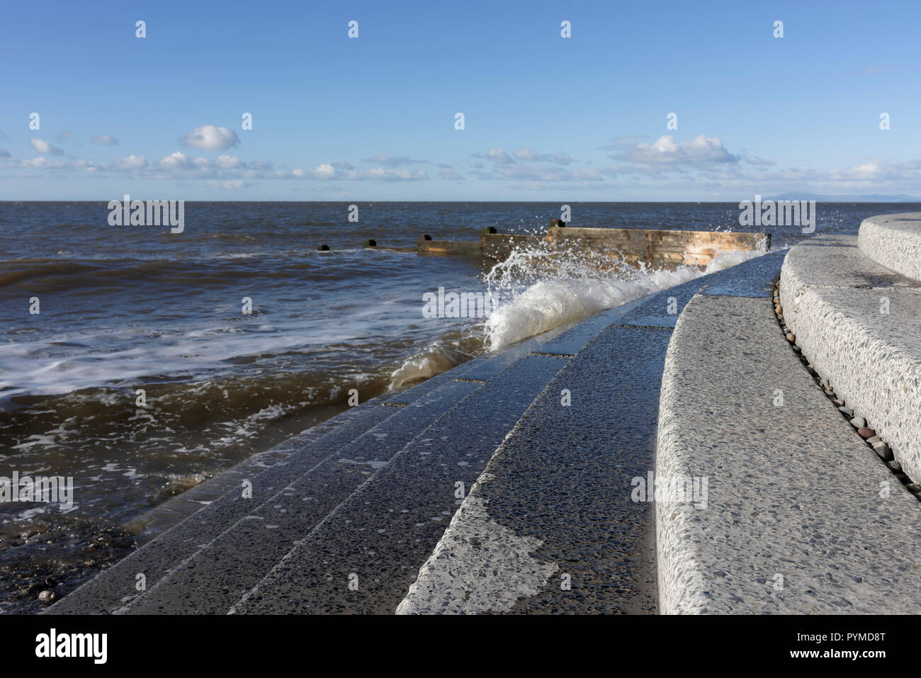 Wave breaking against concrete stepped revetment with timber groyne in ...