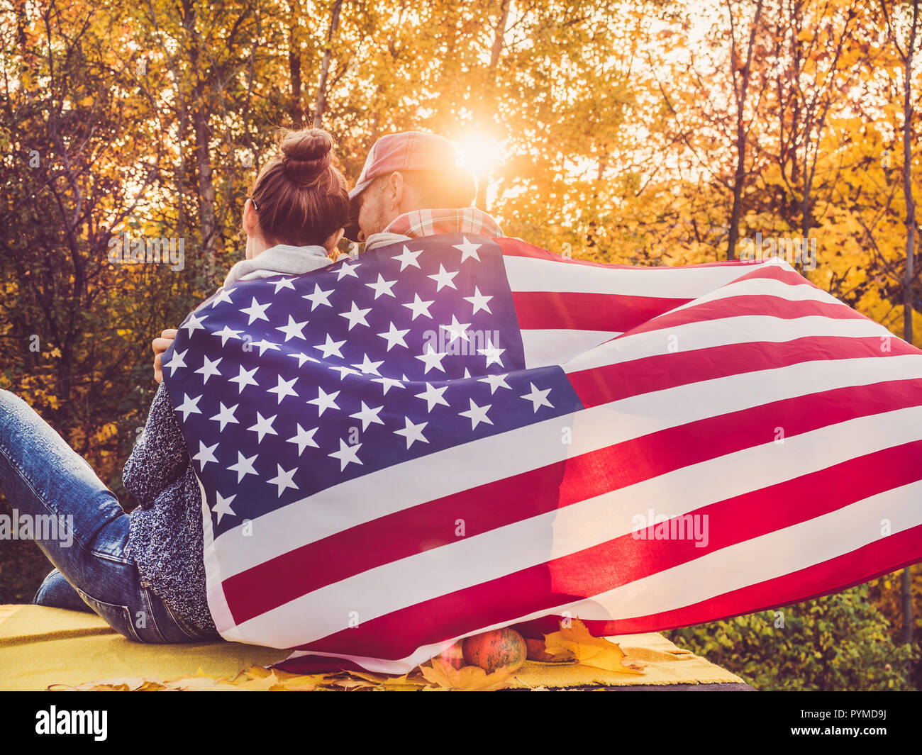 Happy married couple holding the US flag Stock Photo - Alamy