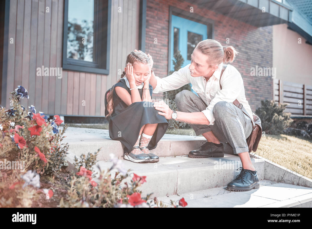Loving young father calming his emotional daughter feeling very worried ...