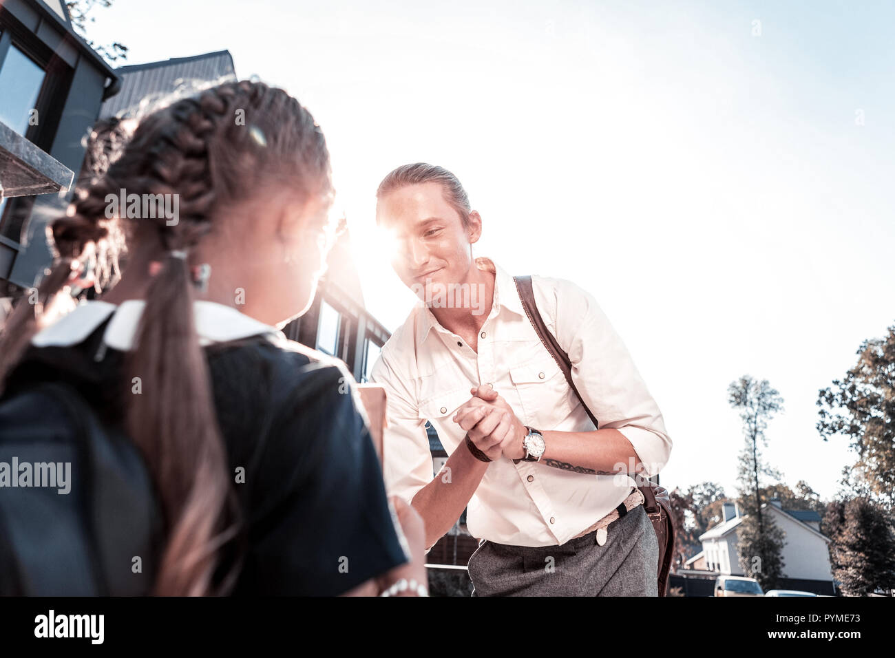 Stylish modern father with tattoo on hand taking his little girl to ...