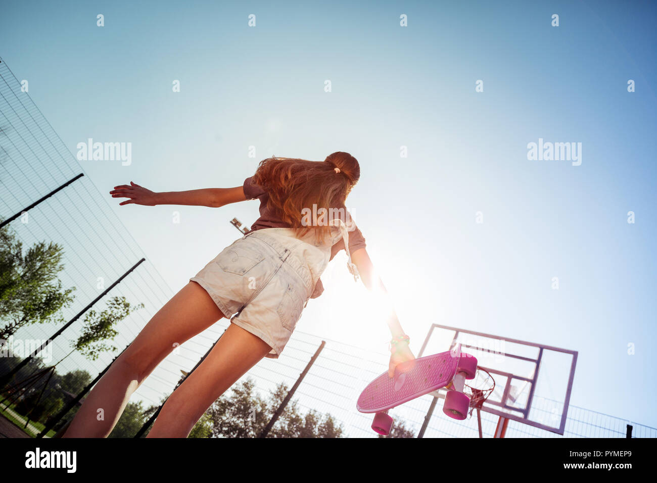 Back view of delighted girl that looking at sky Stock Photo - Alamy