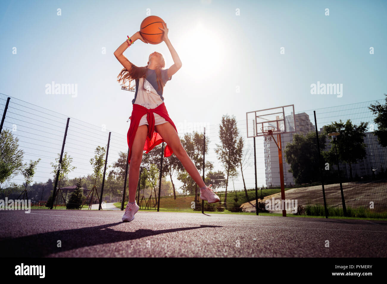 Happy longhaired female person playing with ball Stock Photo - Alamy
