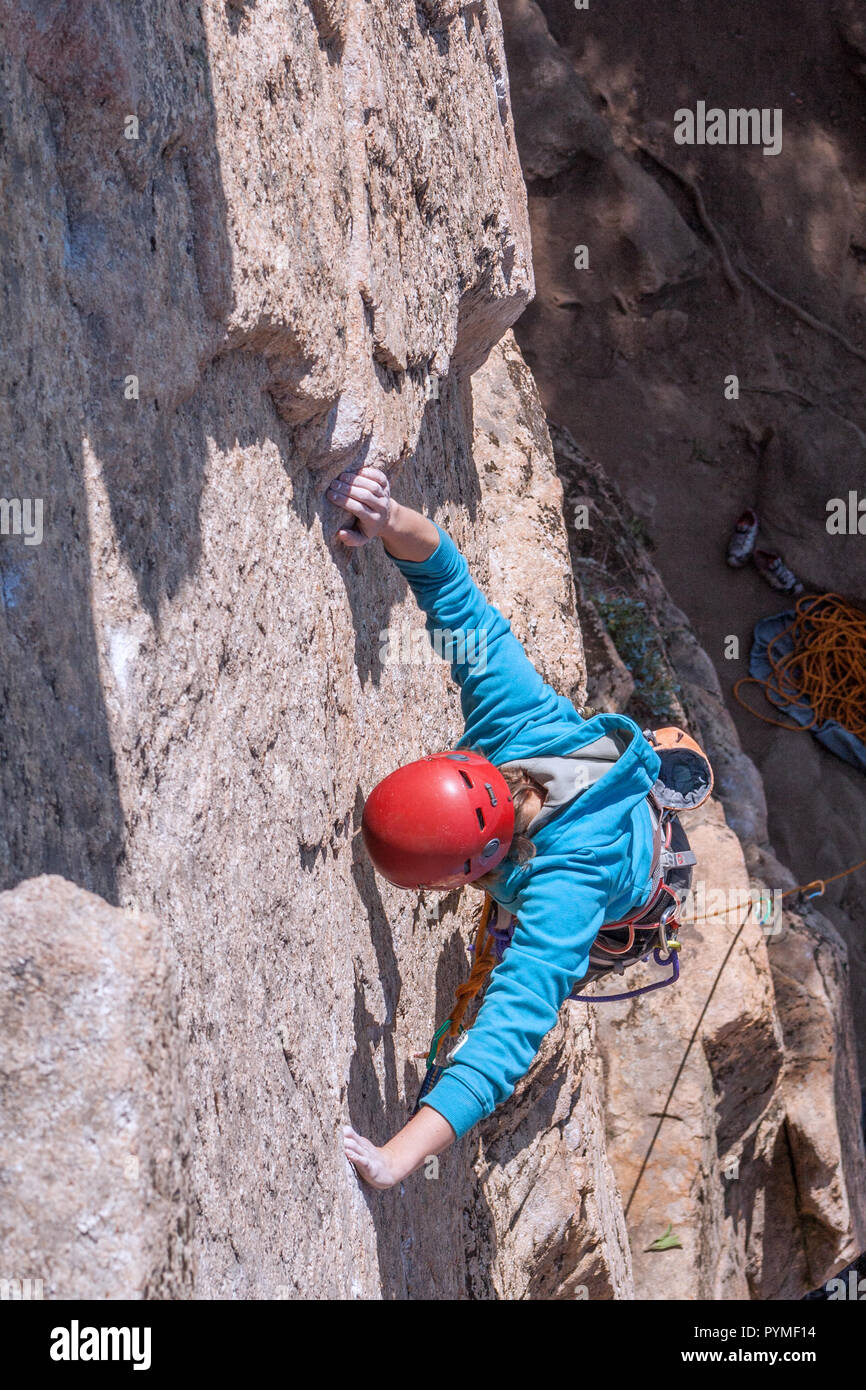 Aerial view of female climber with red helmet climbing a limestone ...