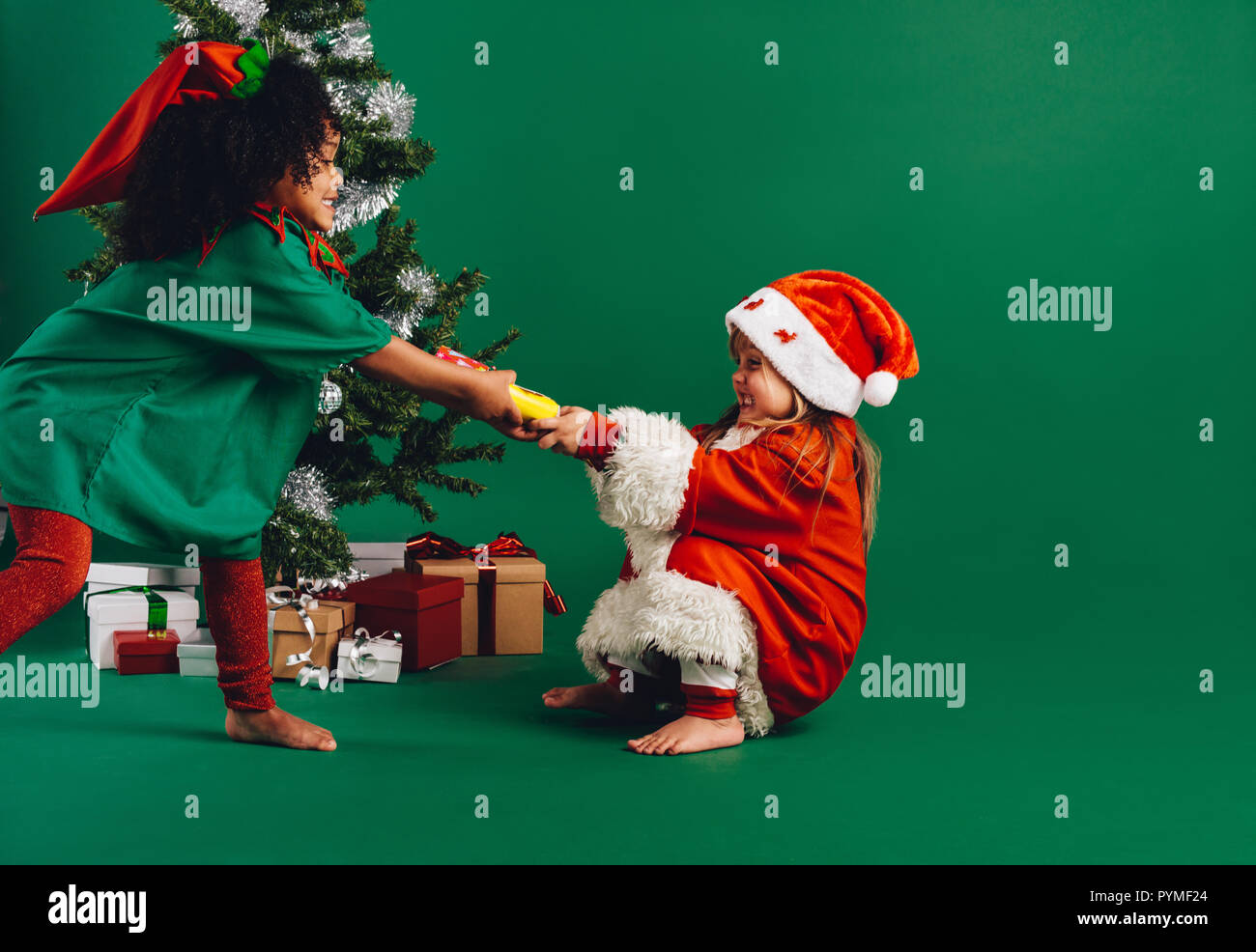 Kids pulling christmas tree hi-res stock photography and images - Alamy