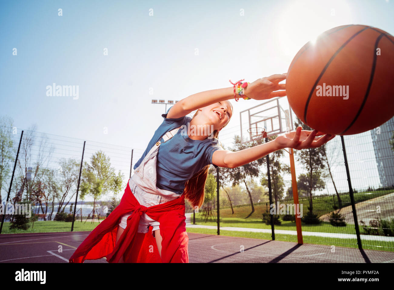 Positive delighted kid trying to catch ball Stock Photo - Alamy
