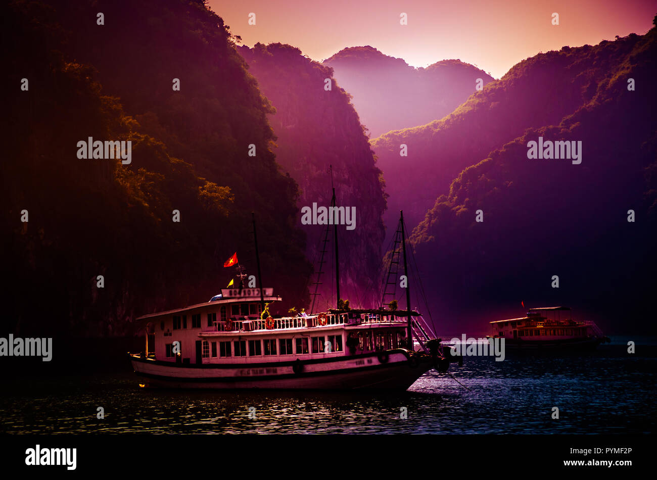 Tourist cruise ship at sunset on Halong Bay, Vietnam Stock Photo - Alamy