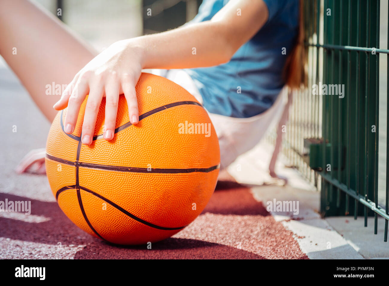 Close up of kind girl that putting hand on ball Stock Photo - Alamy