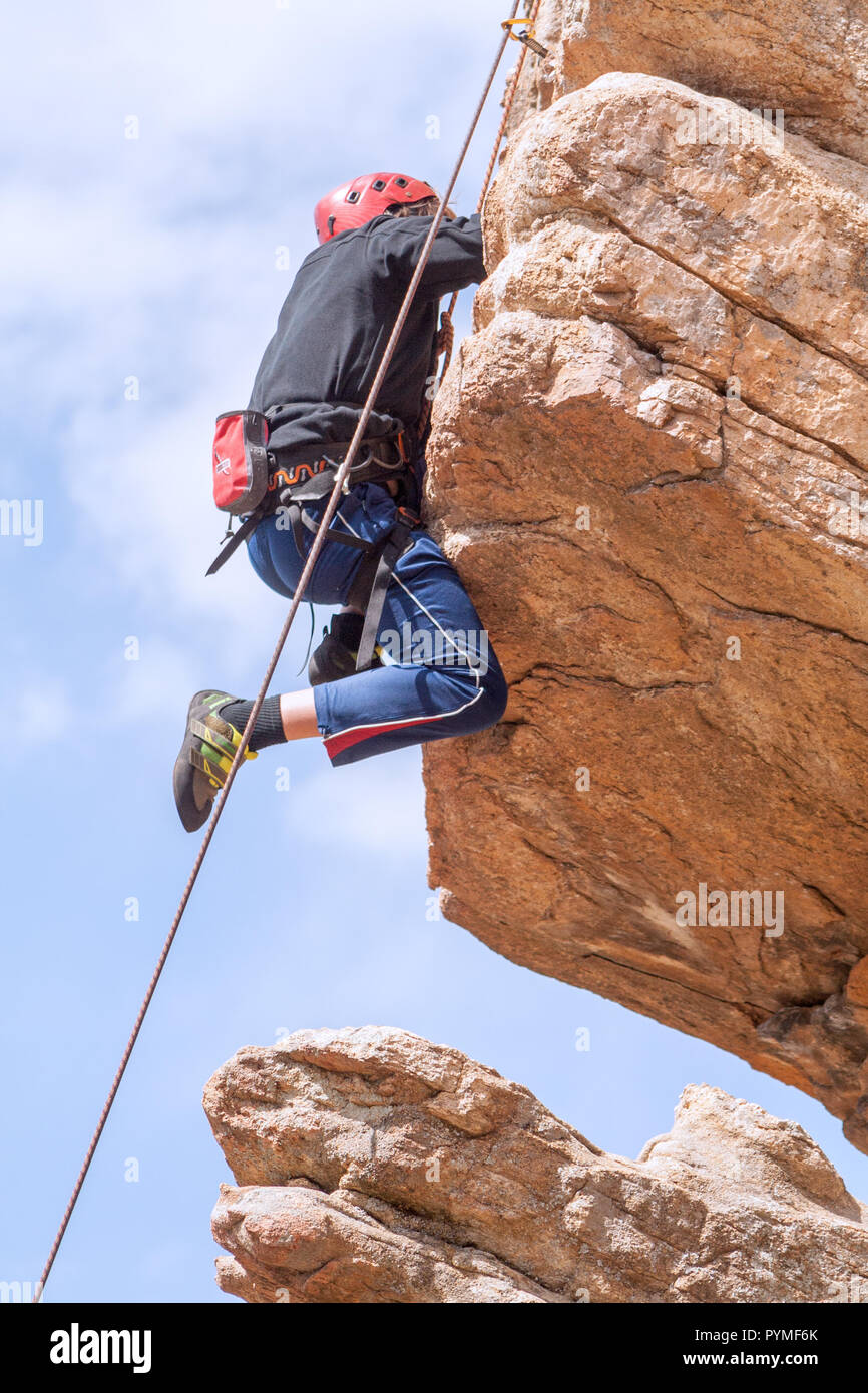 First time climber attempting and struggling to reach the top. Climber ...
