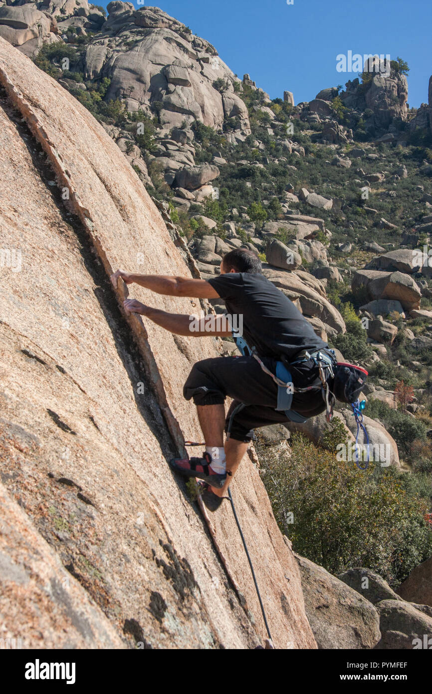 La Pedriza, Madrid, Spain. Rock climber dealing with a crack on a ...