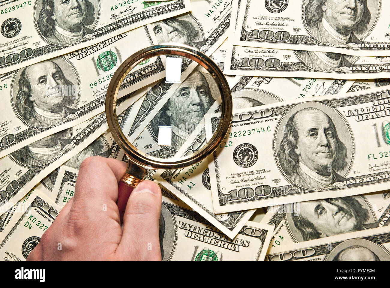 magnifying glass with dollars background Stock Photo - Alamy