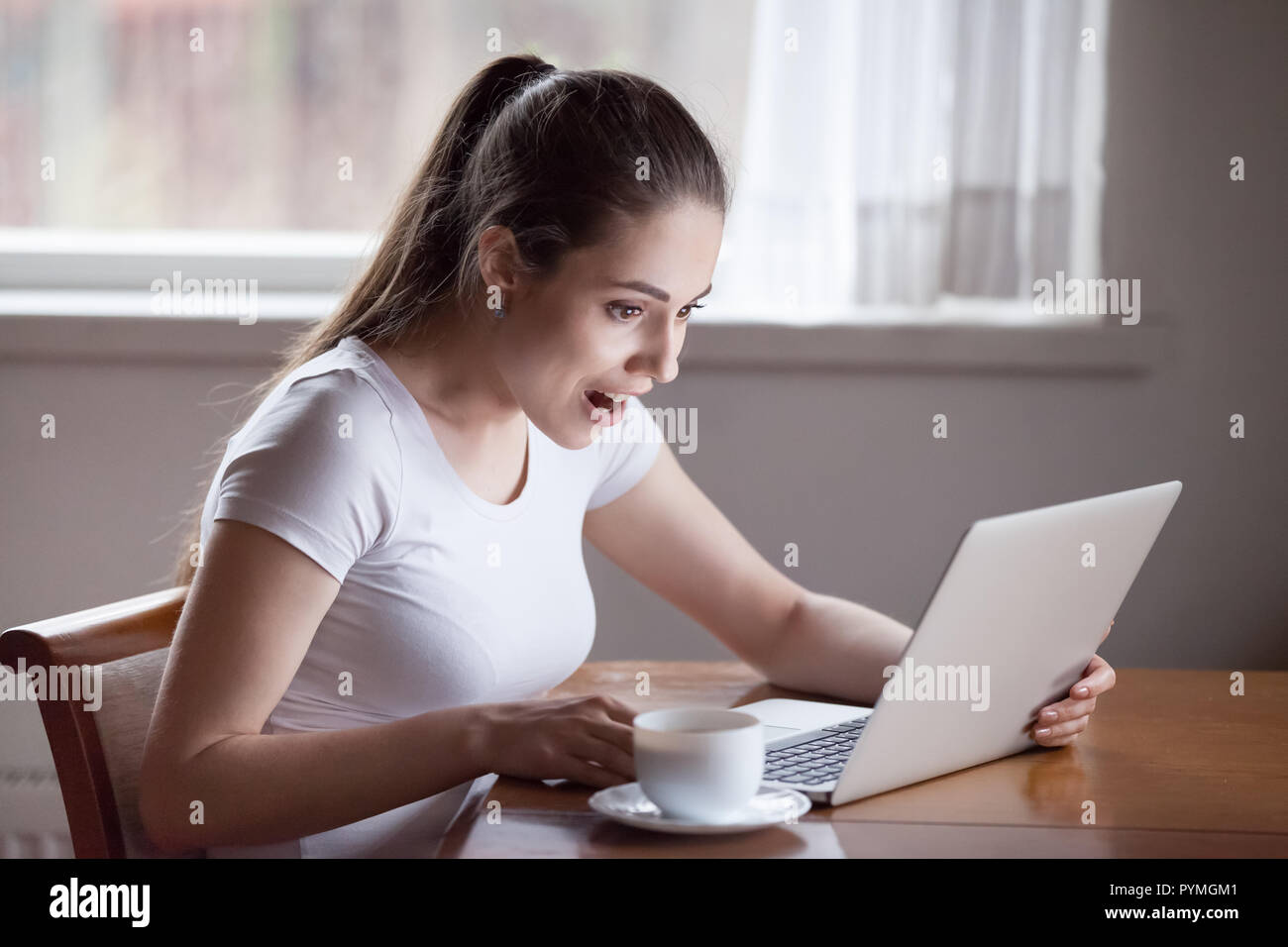 Surprised young woman receive message good news Stock Photo - Alamy