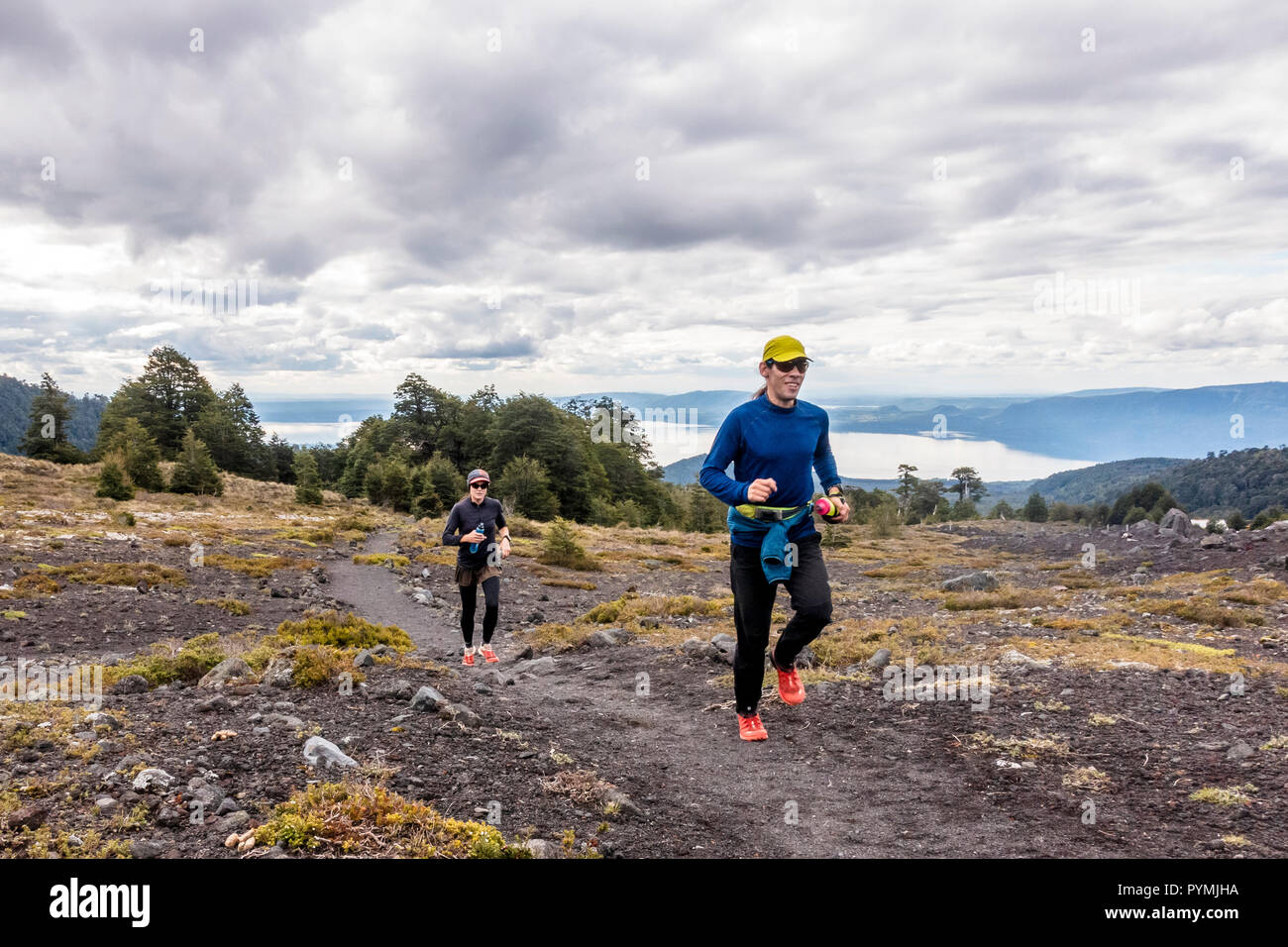 Two people running the trails on Villarica Volcano in Pucon, Chile ...