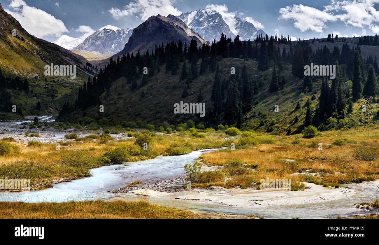 Panorama of beautiful landscape of snowy mountains in green valley of ...