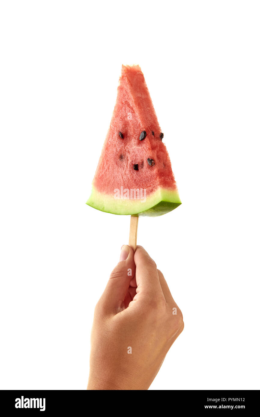A woman's hand holds a juicy piece of watermelon lolly on a white ...