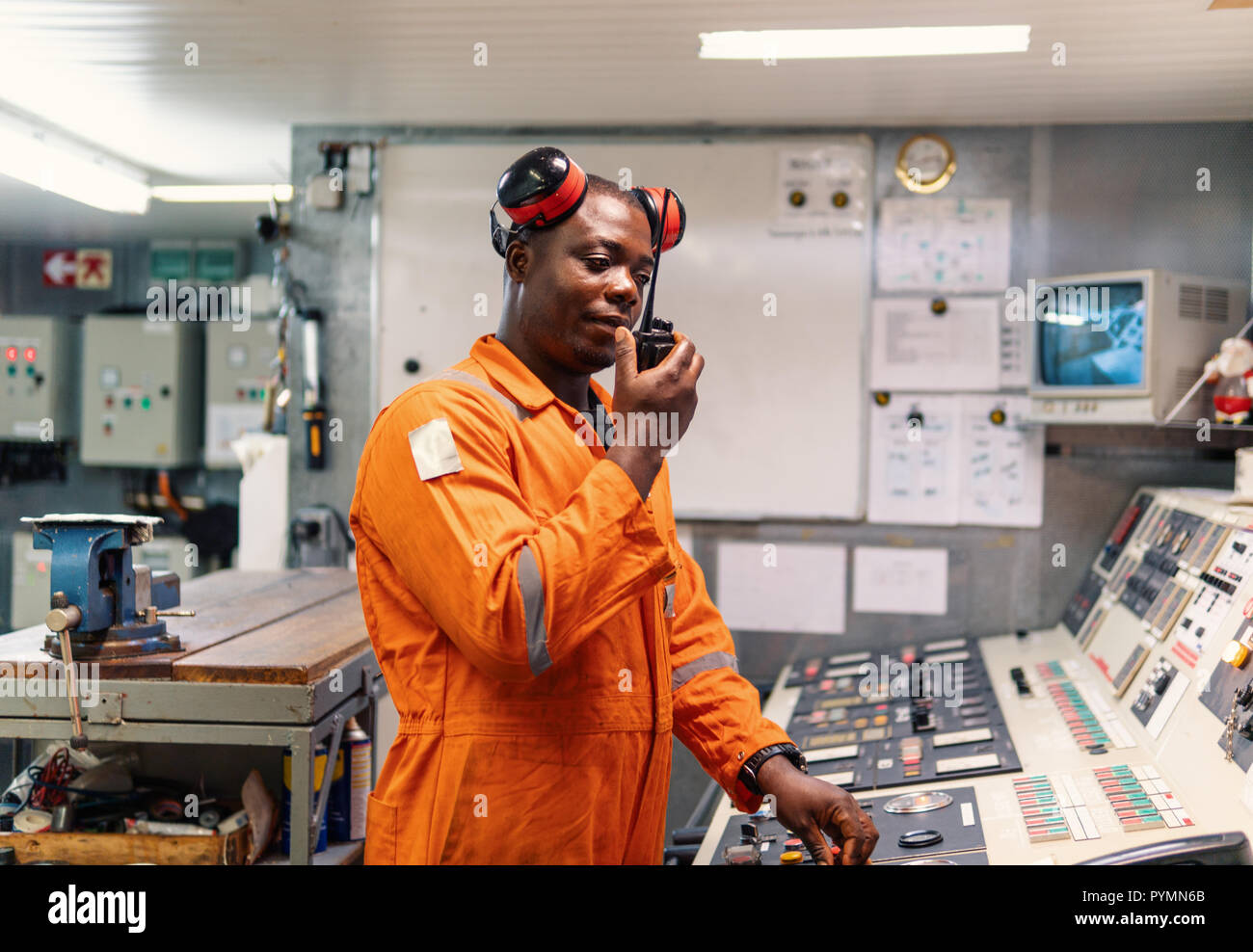Marine engineer officer working in engine room Stock Photo - Alamy