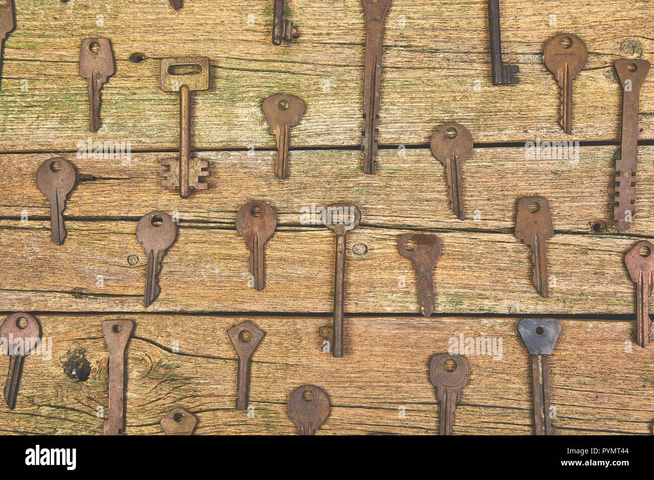 Collection of many different old retro keys in order on wooden rustic ...
