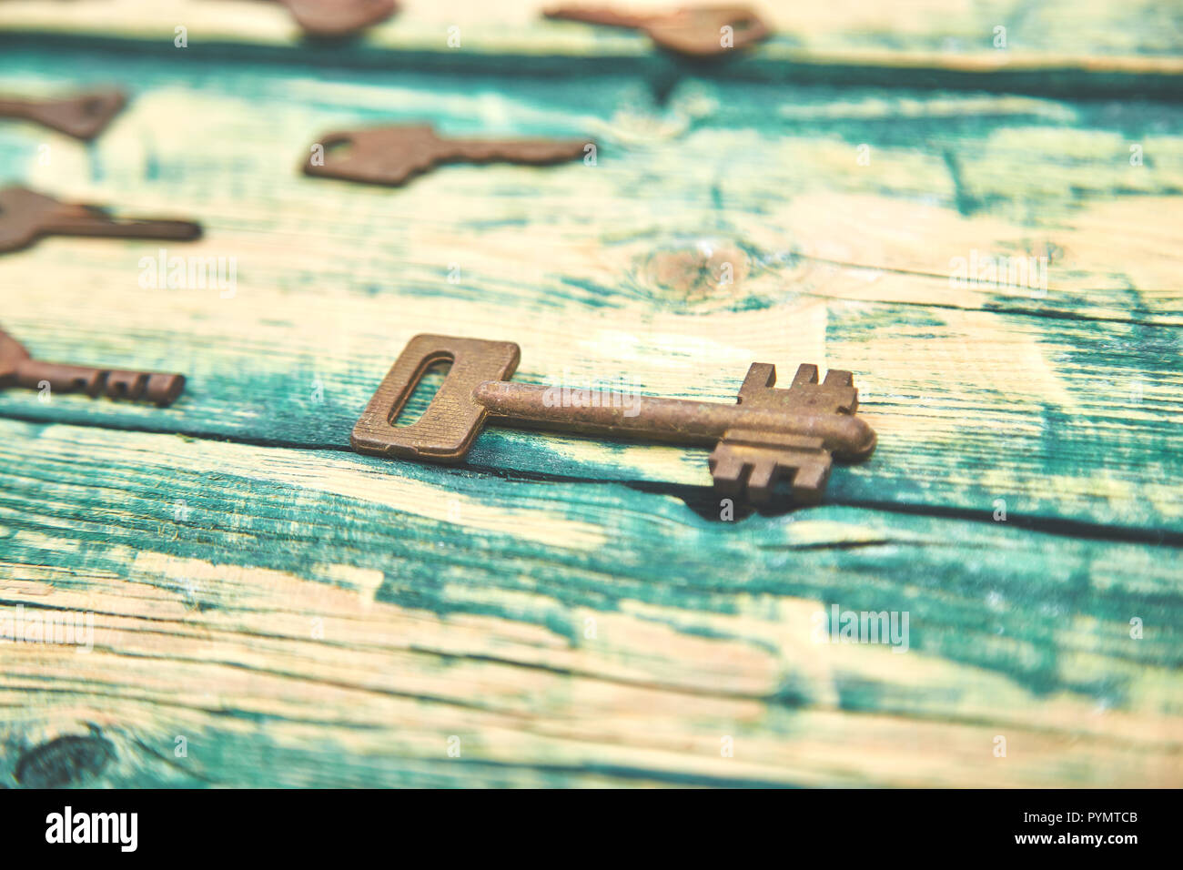 Collection of many different old retro keys in order on wooden rustic ...