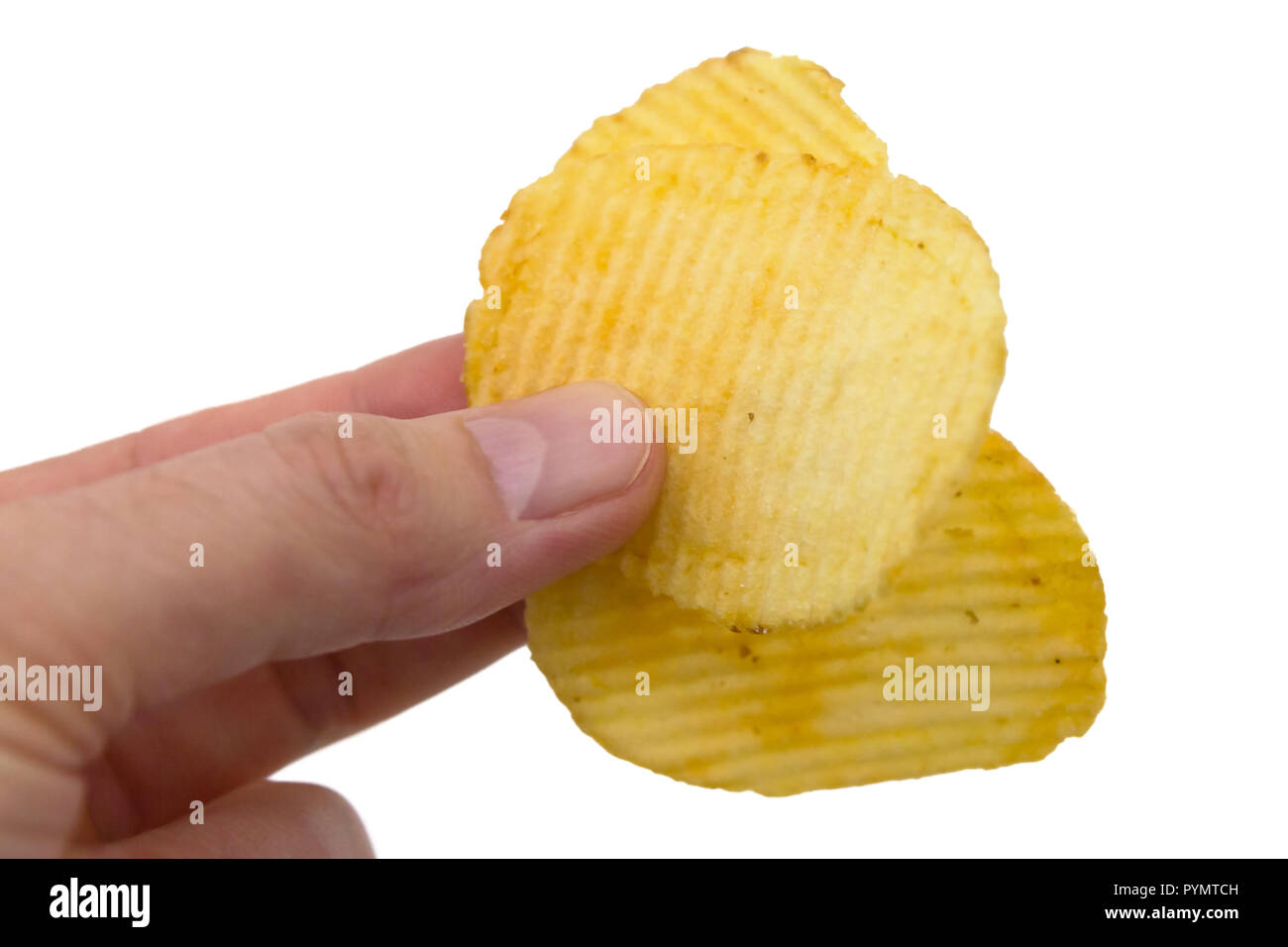 Rippled crisps held between fingers, ready to eat Stock Photo - Alamy