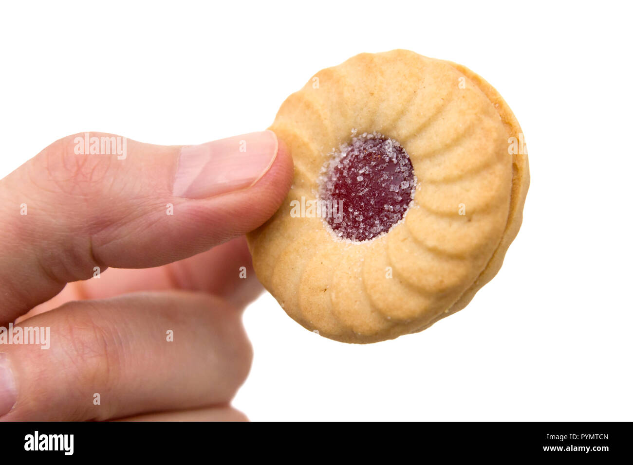 Jam ring biscuit held in mans fingers, ready to eat Stock Photo - Alamy
