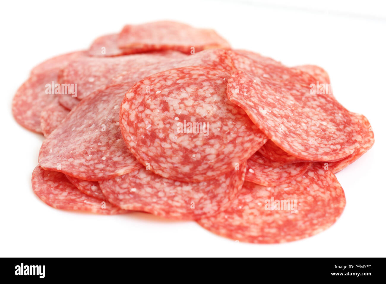 Thin slices of salami in a random pile on white background Stock Photo ...