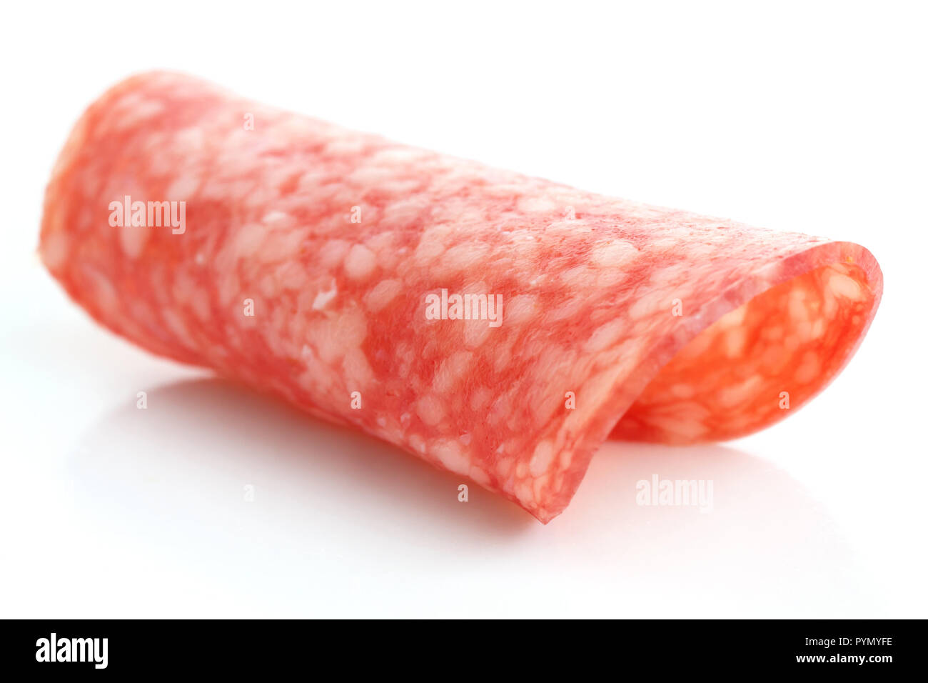 Thin slices of salami rolled into shape on white background Stock Photo ...