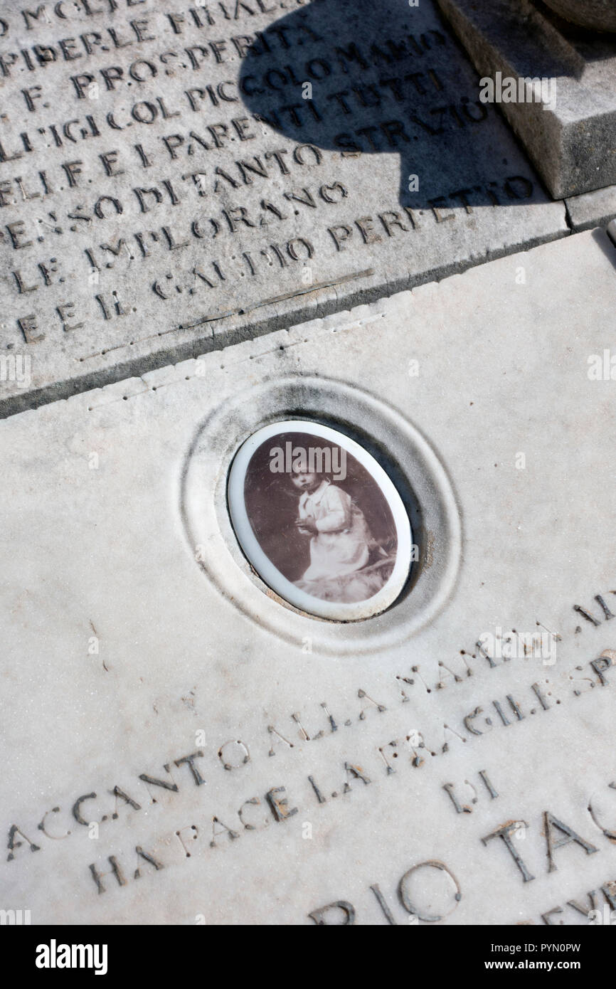Commemorative plaque on a gravestone in a cemetery with the old image ...