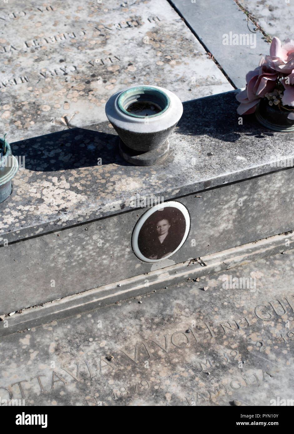 Commemorative plaque on a gravestone in a cemetery with the old image ...