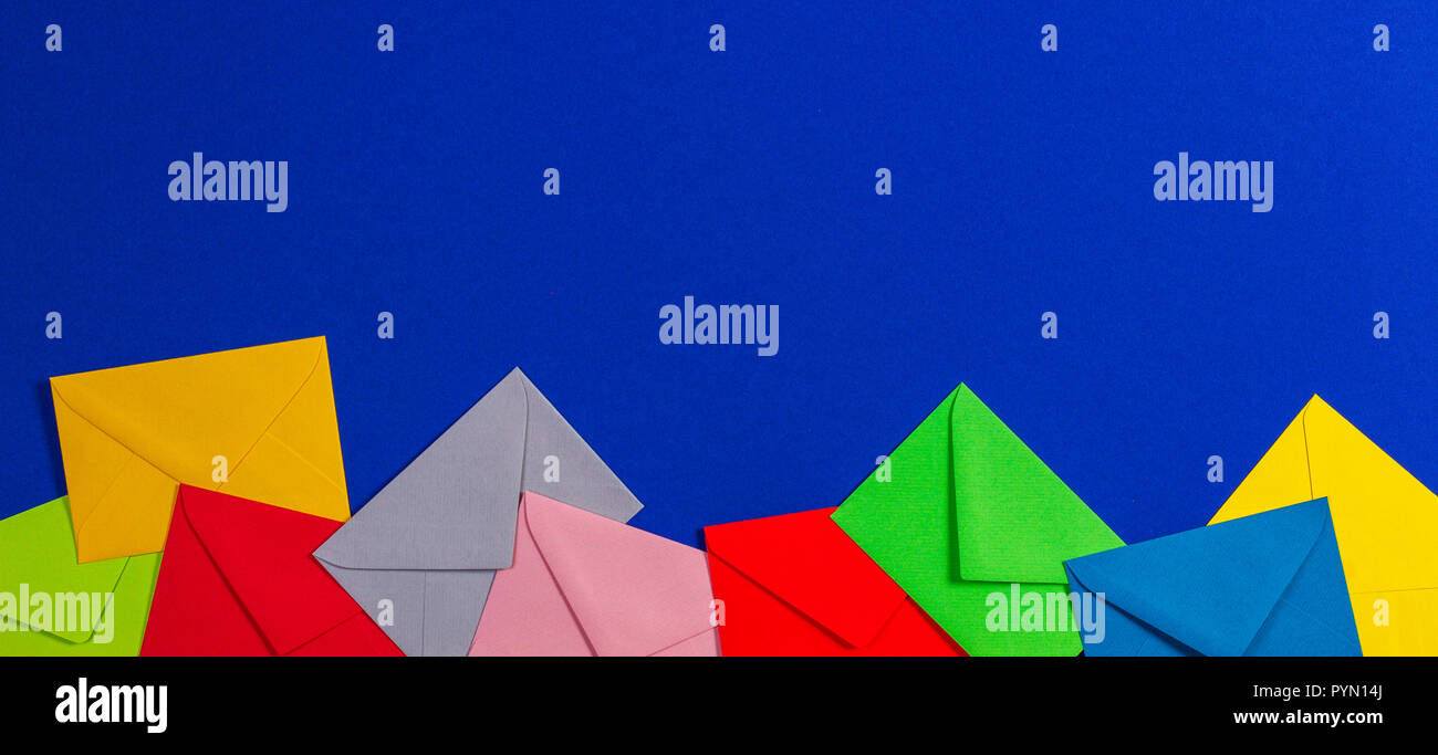 Colorful envelopes on blue background, top view Stock Photo - Alamy