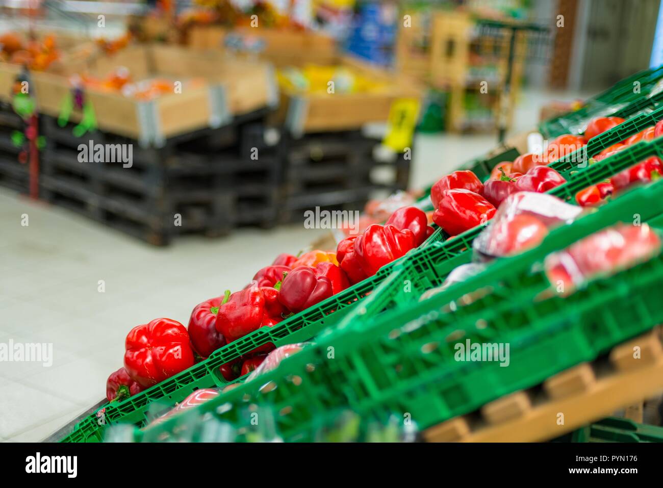 Red fresh paprika pepper in green plastic box in supermarket Stock ...