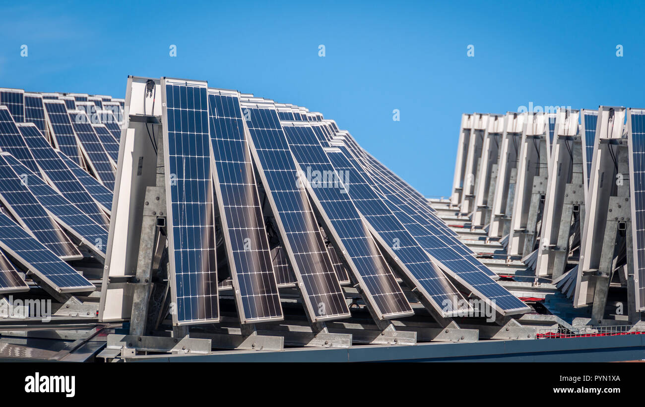 Solar panels in a strange pattern on the roofr Stock Photo - Alamy