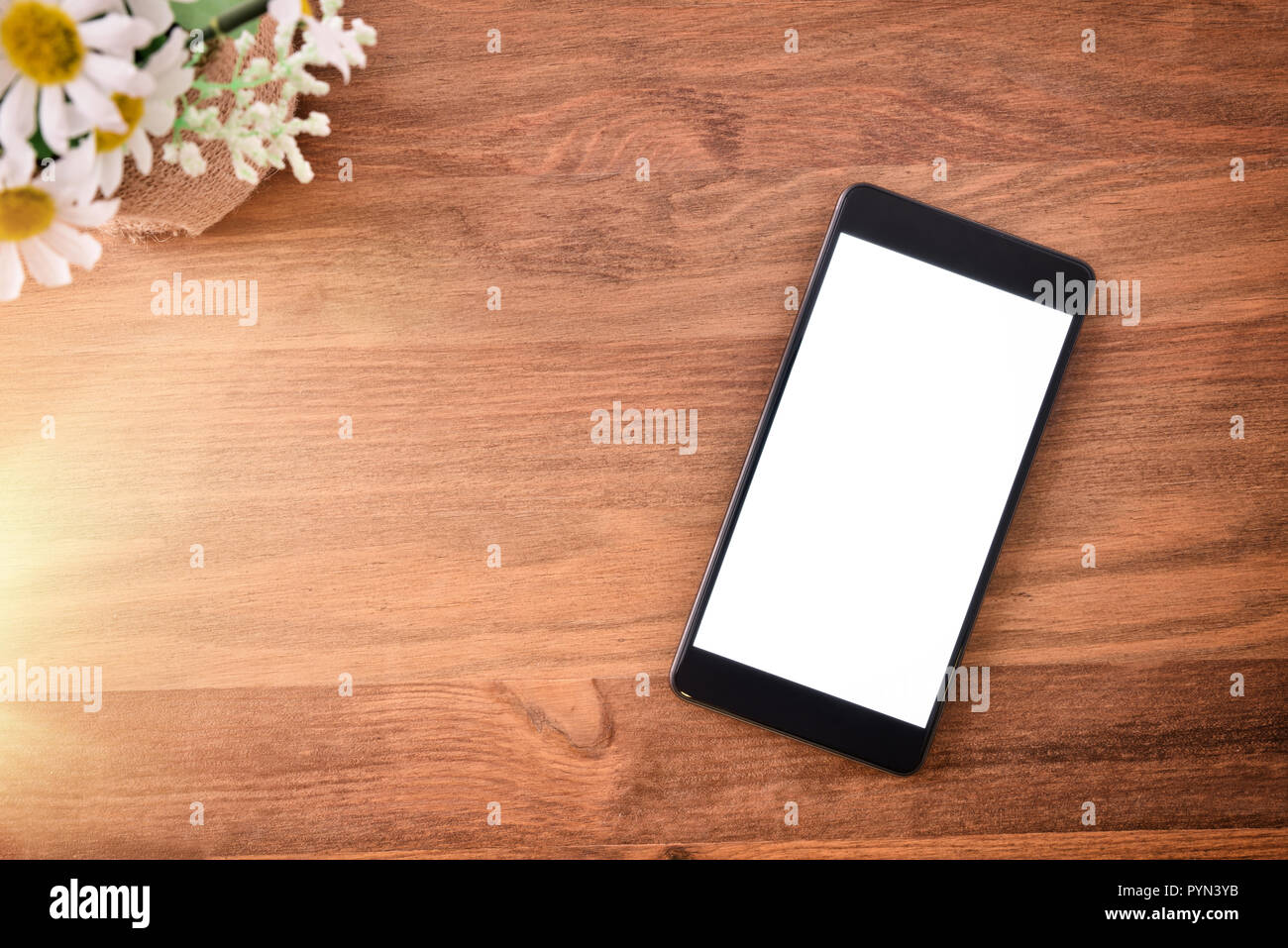 Black portable phone on wooden isolated table. Top view. Horizontal ...